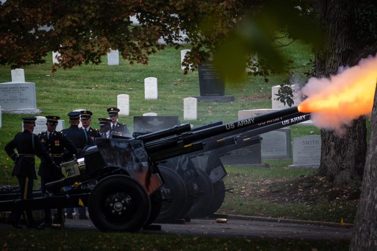 Shown here are the minute guns at Arlington National Cemetery, paying ...